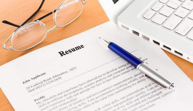 Resume with Pen by Laptop on Table | Langports